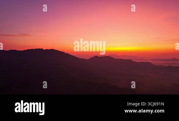 aerial view A serene landscape capturing the soft hues of dawn as mist ...