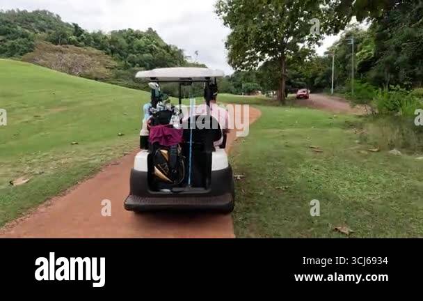 Golf cart driving along a scenic course path Stock Video Footage - Alamy