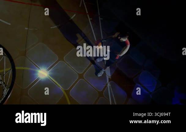 Male athlete crouching at free-throw line raising basketball and ...