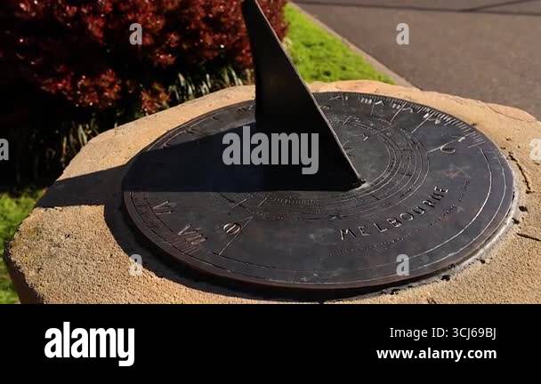 Sundial casting shadow in Melbourne park Stock Video Footage - Alamy
