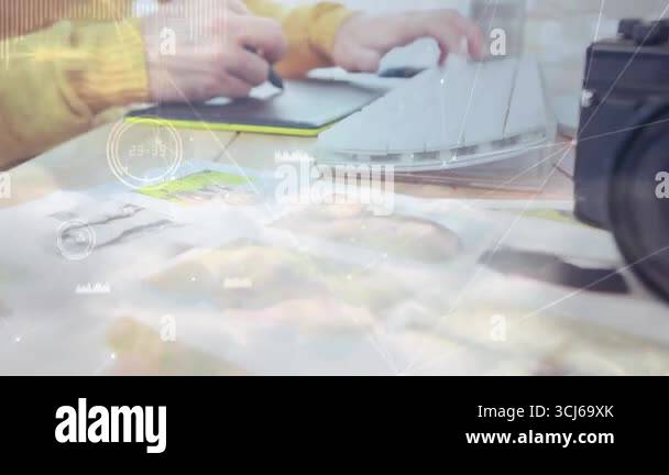 Designer hands hovering over keys initiating network graphics while ...