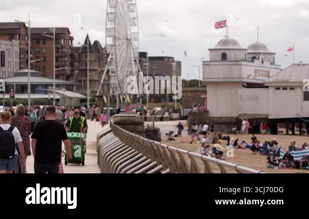 WESTON, UK - AUGUST 8, 2025 - Tourists enjoying summer holidays walking ...