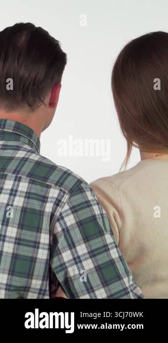 A heartwarming rear view of a loving couple, their noses softly ...