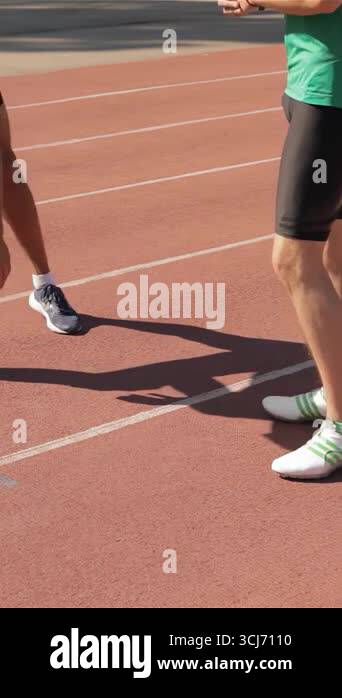 Two focused Caucasian male athletes are energetically warming up on the ...