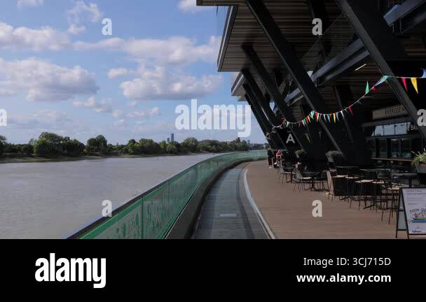 LONDON, UK - AUGUST 8, 2025 - Outdoor tables and chairs inviting ...