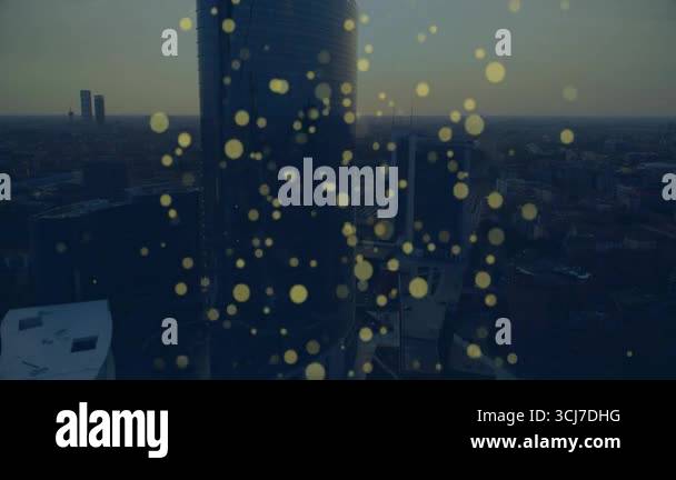 Fading daylight starting golden orbs drifting and swirling around glass skyscraper for soft ...