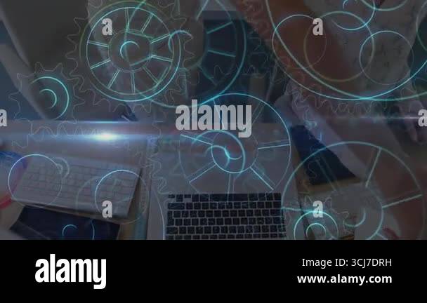two colleagues starting design tasks after fading gear overlays while ...