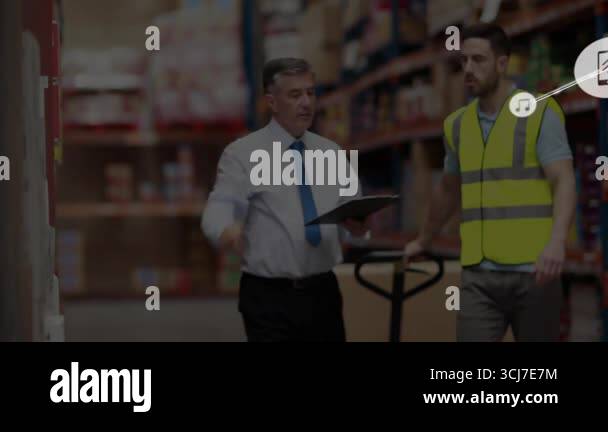 Warehouse supervisor tapping tablet and worker pushing jack observing ...