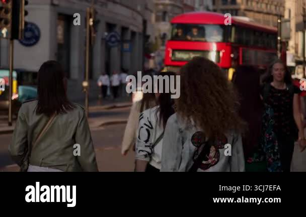 LONDON, UK - AUGUST 5, 2025 - Tourists walking on a street in London ...