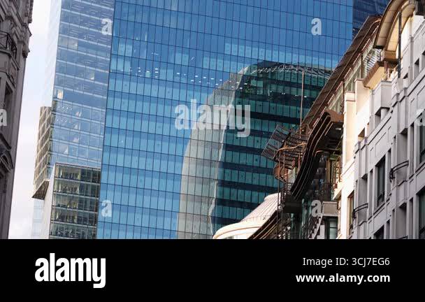 LONDON, UK - AUGUST 5, 2025 - Modern glass skyscraper reflecting ...