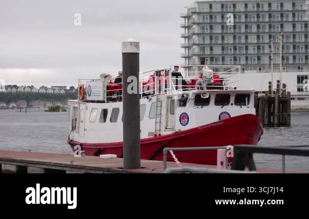 CARDIFF, UK - AUGUST 8, 2025 - Red and white tour boat carrying ...