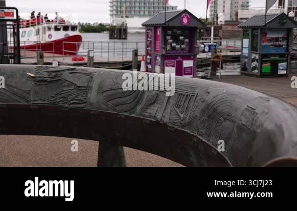 CARDIFF, UK - AUGUST 8, 2025 - Circular bronze sculpture showing bas ...