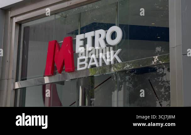 CARDIFF, UK - AUGUST 8, 2025 - Metro Bank logo displayed on a glass ...