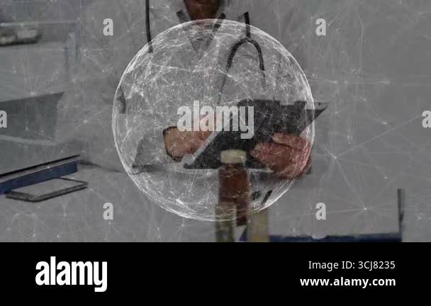 Male doctor tapping and scrolling tablet charting with stethoscope ...