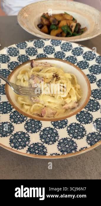 pasta carbonara fork colorful bright blue plate with circles restaurant ...