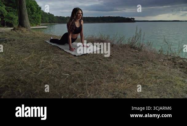 Enjoy a serene yoga session right by a beautiful lake, perfectly showcasing tranquility and ...