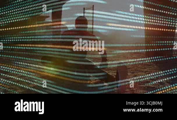 Man placing hand on sand under pier at sunset, brushing sand while tech dots drifting above ...