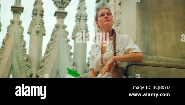 Woman sightseeing among ornate spires on Milan cathedral rooftop in ...