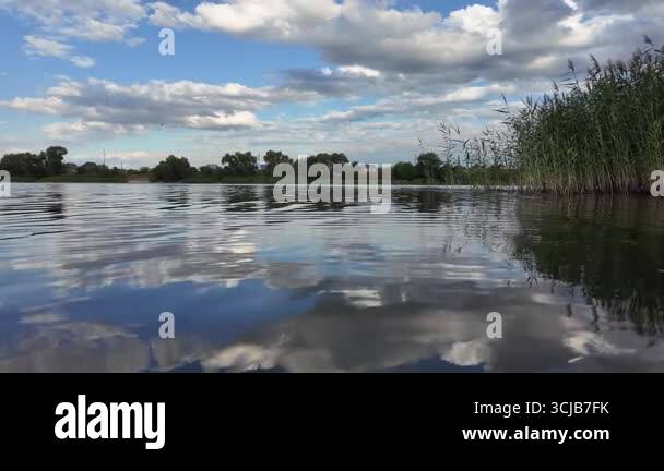 Slow motion video of water in a lake close up. Waves splashing foam in ...