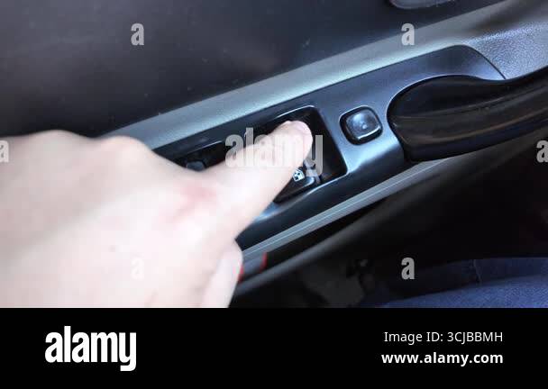 analog window lift buttons. man opens window in car. old buttons in car ...