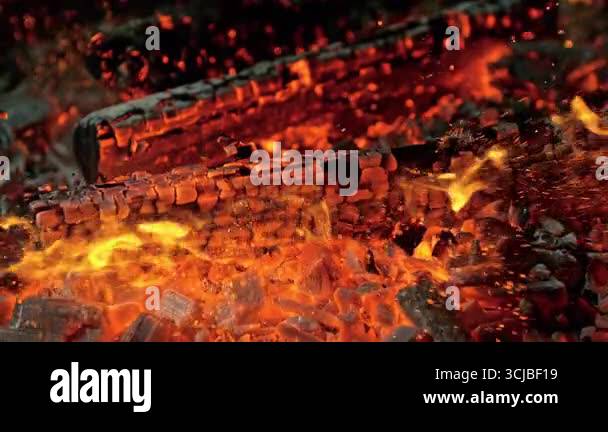 Super Slow Motion of Burning Wood Falling Into Glowing Embers, and ...