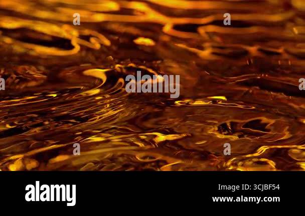 Super Slow Motion Shot of Waving Dark Golden Liquid Surface at 1000fps ...