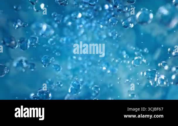 Super Slow Motion Shot of Flying Water Drops On Blue Background at ...