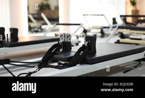 Reformer machines in studio, camera moving right. Pilates equipment ...