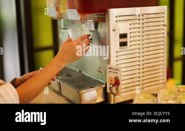 Person using machine to pour apple juice Stock Video Footage - Alamy