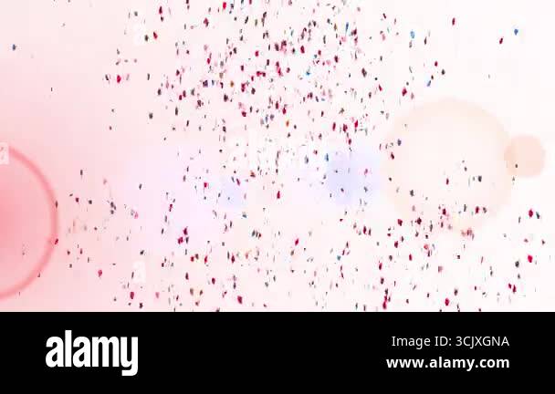 Animation of confetti falling over blue light against spots of light on ...