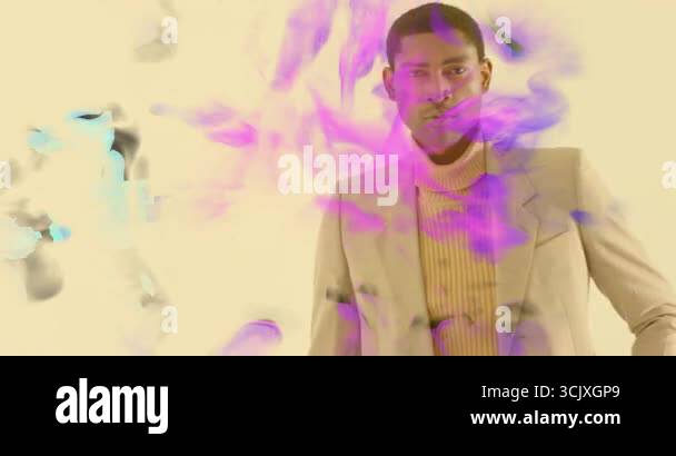 Male model initiating swirling purple and cyan smoke around suit jacket ...
