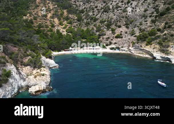 Aerial view of the beautiful Cala Llentrisca beach with turquoise water ...