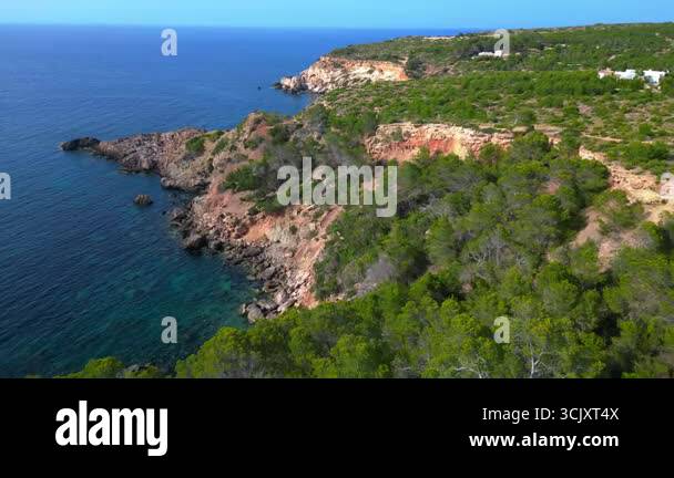 aerial view of the ibiza coastline, showcasing the rugged cliffs and ...
