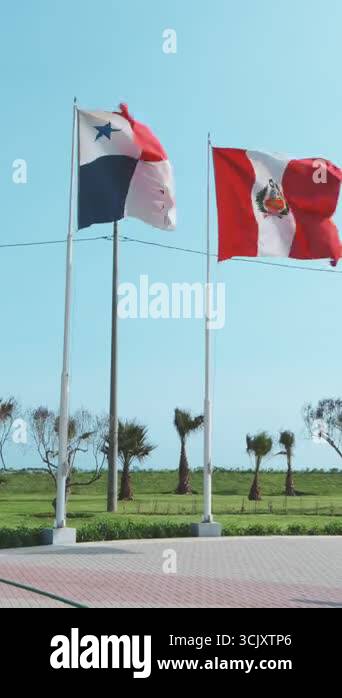 National flags of panama and peru waving in the wind on flagpoles on a ...