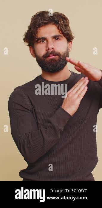 Tired serious upset young Lebanese man showing timeout gesture, limit ...