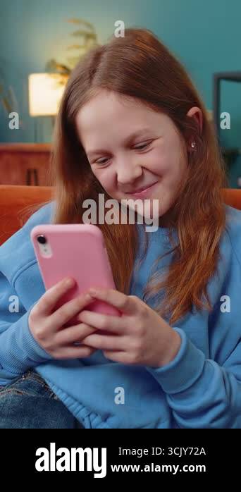 Cheerful young girl texting share messages on smartphone social media ...