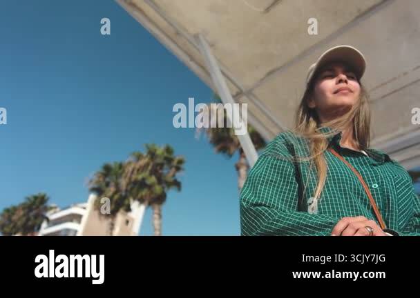 Female lifeguard standing in a white lifeguard tower, ensuring beach ...
