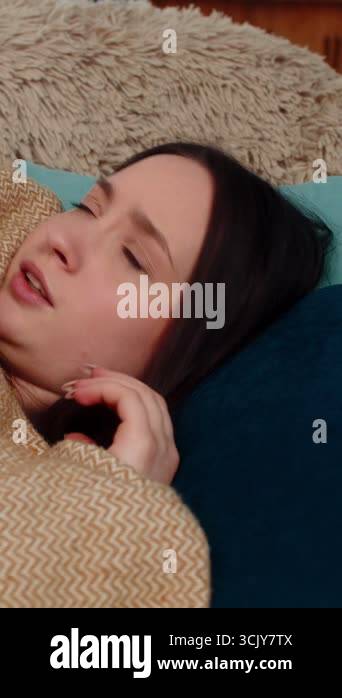 Young woman at home suddenly waking up terrified on sofa after scary ...