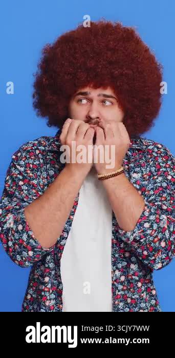 Stressed depressed man with Afro hairstyle wig terrified about danger ...
