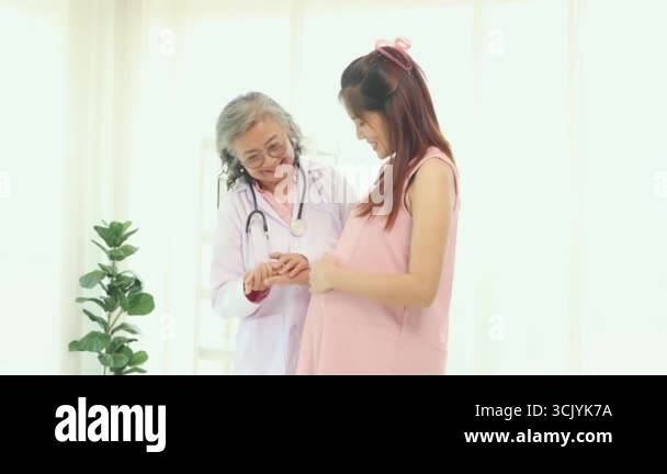 Senior doctor's hands use stethoscope check the health fetus measure ...