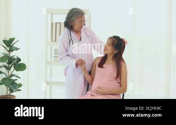 Senior doctor's hands use stethoscope check the health fetus measure ...