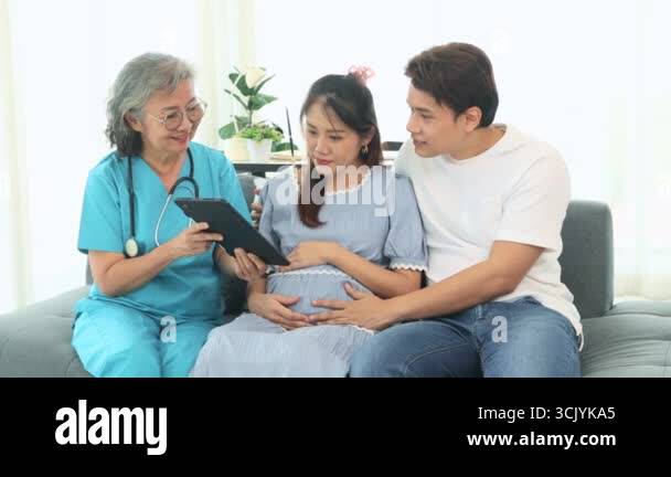 Senior gynecologist meets pregnant women and their husbands in the ...