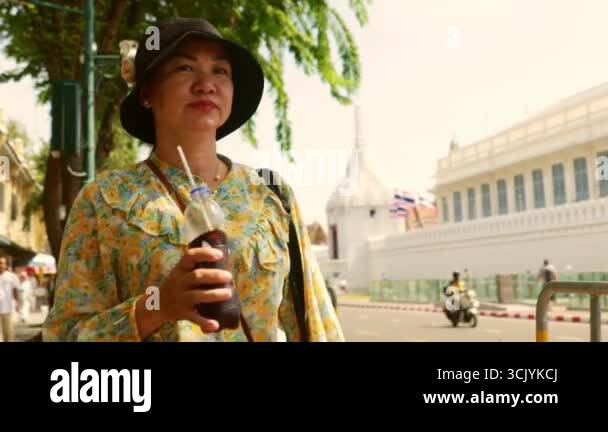 Asian adult woman tourist happily visiting Wat Phra Kaew and Grand ...