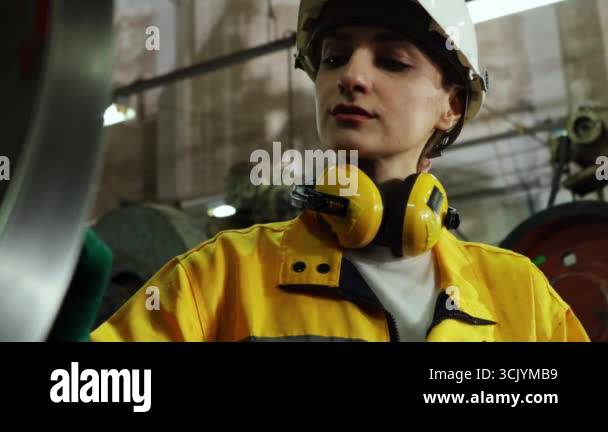 Caucasian technician woman beautiful wearing safety helmet earmuffs ...