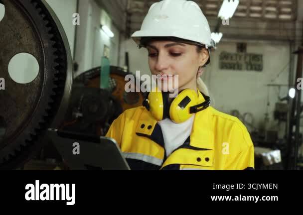 Caucasian technician woman beautiful wearing safety helmet earmuffs ...