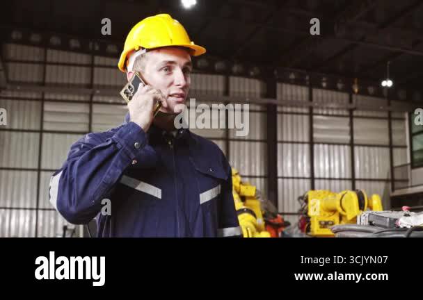 Male robot engineer talks on the phone to consult with the supervisor ...