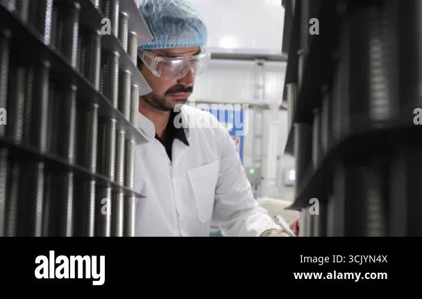 Male QC worker checks the quality of aluminum cans containing canned ...