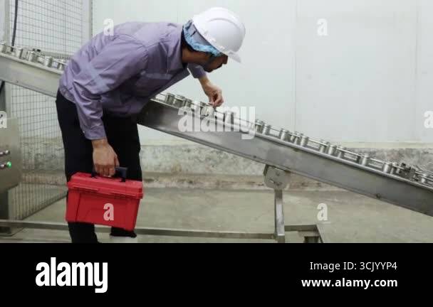 Large factory production line supervisor checks the production quality ...