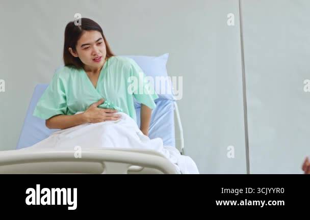 Pregnant female doctor examines and questions the symptoms weak female ...