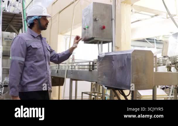 Large factory production line supervisor checks the production quality ...